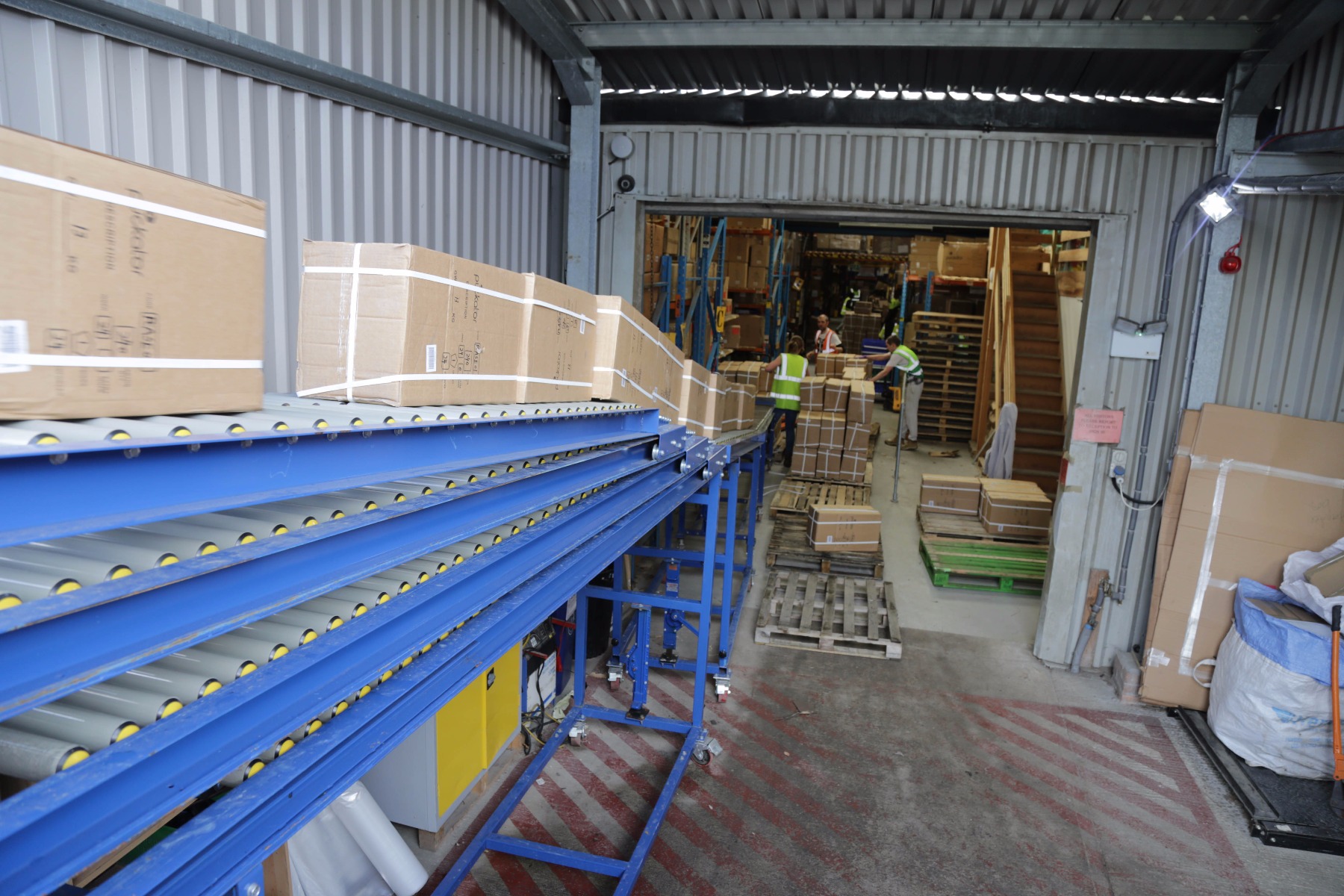 Gravity roller conveyor vehicle container unloading - AS Conveyor Systems
